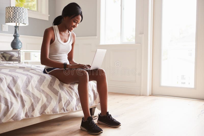 Young Black Woman Ready for Exercise, Using Laptop Computer Stock Photo ...