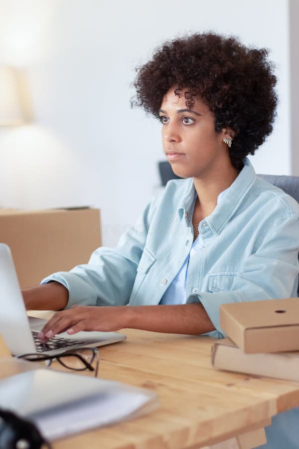 Young Black Woman Sitting at Desk and Working on Computer Stock Photo ...
