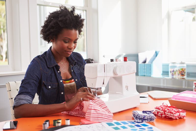 Young Black Woman Stitching Fabric Using a Sewing Machine Stock Image ...