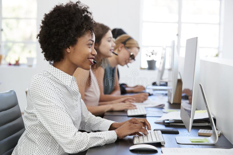 Young Black Woman Working at Computer in Office with Headset Stock ...