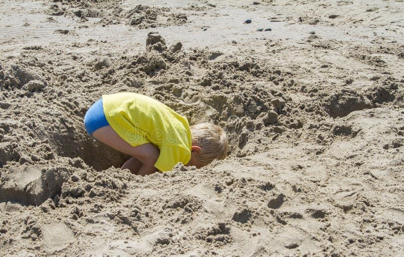 Boy digging hole in sand stock photo. Image of game, closeup - 18970048