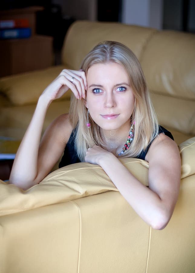 Young Blond Lady Seating on the Leather Sofa Stock Photo - Image of ...