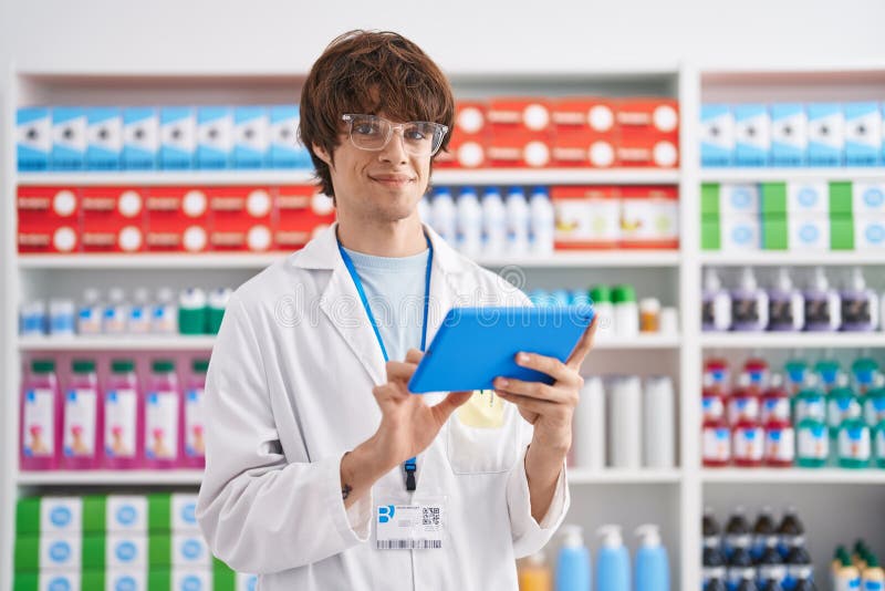 Young Blond Man Pharmacist Using Touchpad Working at Pharmacy Stock ...