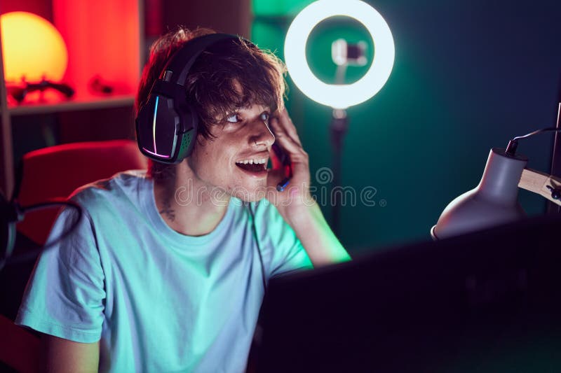 Young Blond Man Playing Video Game Using Computer at Gaming Room Stock ...