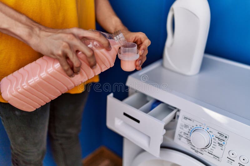 Young Blond Man Pouring Detergent at Laundry Room Stock Photo - Image ...