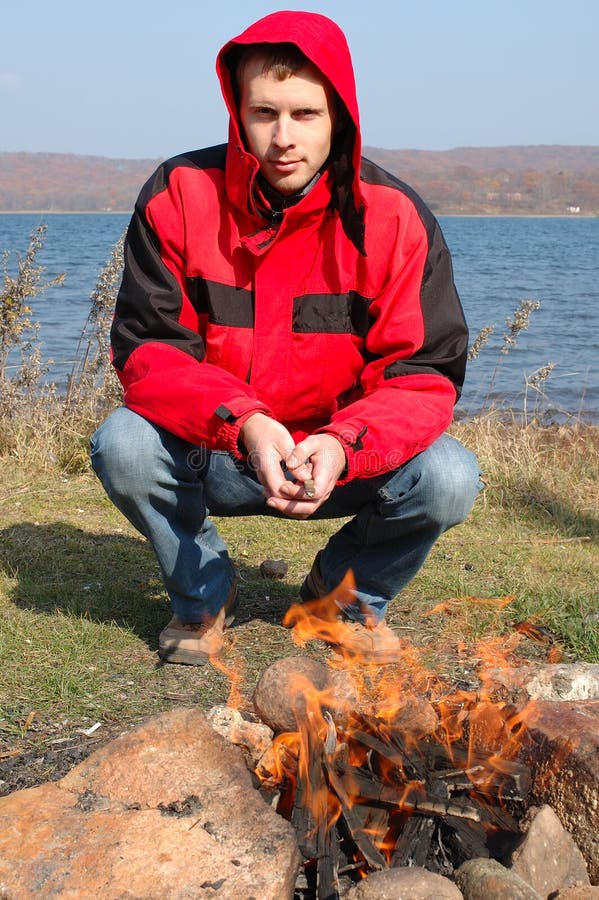 Young Blond Man in Red Jacket Sit Near Fire. Stock Photo - Image of ...