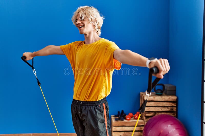 Young Blond Man Smiling Confident Using Elastic Band Training at Sport ...