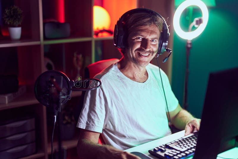 Young Blond Man Streamer Playing Video Game Using Computer at Gaming ...