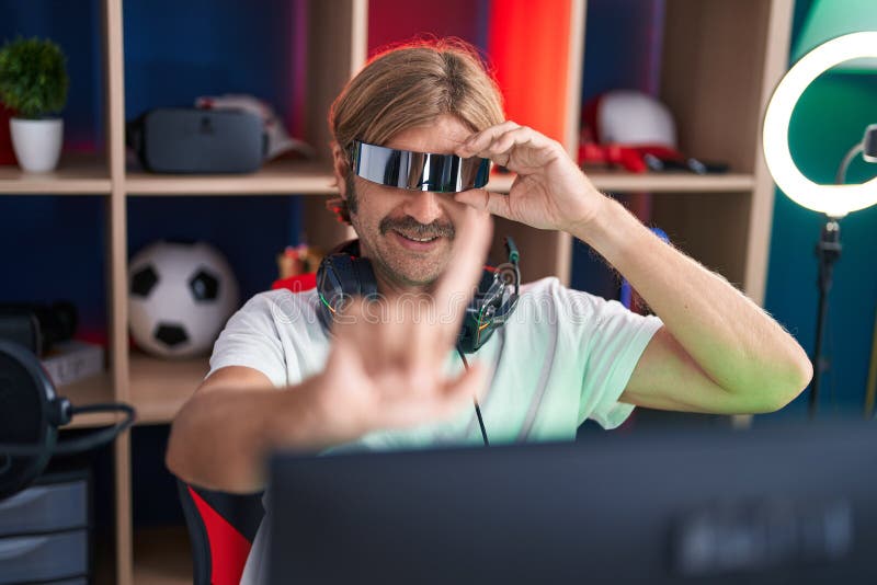 Young Blond Man Streamer Playing Video Game Using Virtual Reality ...