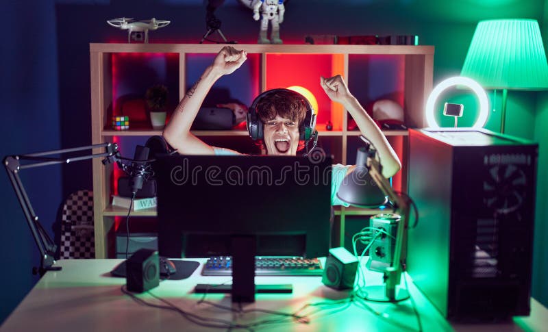 Young Blond Man Streamer Playing Video Game with Winner Expression at ... Young Blond Man Streamer Playing Video Game with Winner Expression at ...