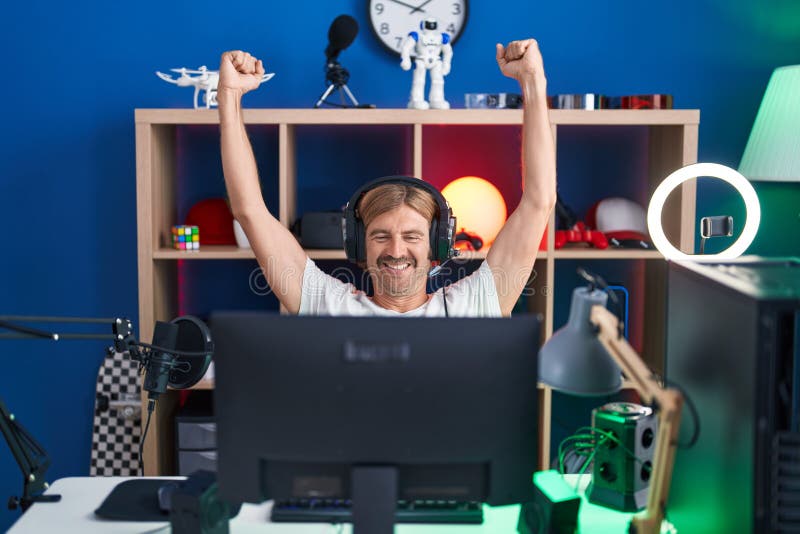 Young Blond Man Streamer Playing Video Game with Winner Expression at ...