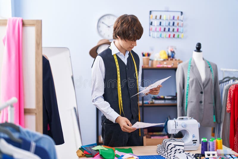 Young Blond Man Tailor Looking Clothing Design at Clothing Factory ...