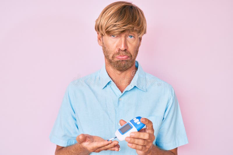 Young Blond Man Using Glucose Meter Depressed and Worry for Distress ...