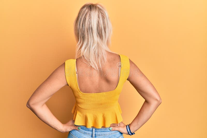 Young Blonde Girl Wearing Casual Clothes Standing Backwards Looking