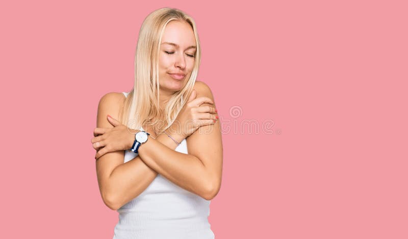 Young Blonde Girl Wearing Casual Style With Sleeveless Shirt Hugging