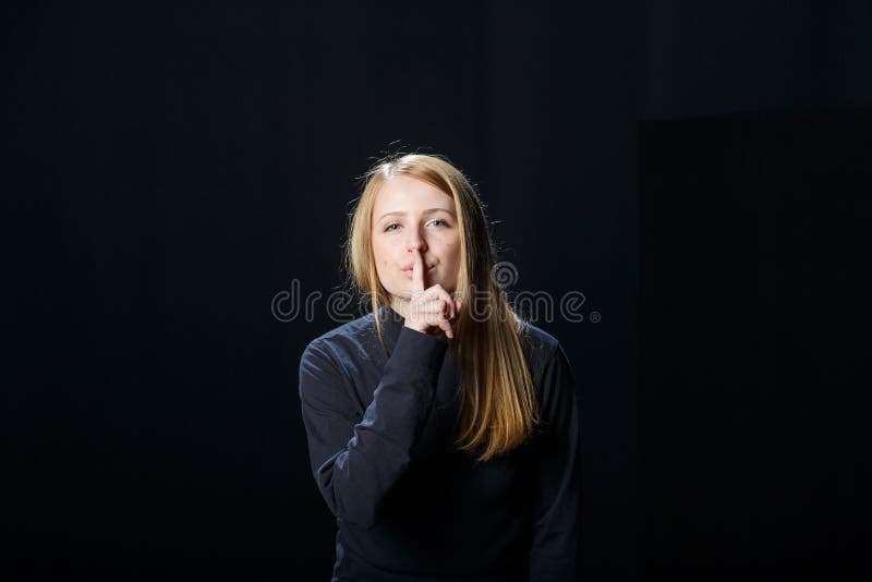 A Young Blonde Leaned Her Finger To Her Lips Against Stock Image ...