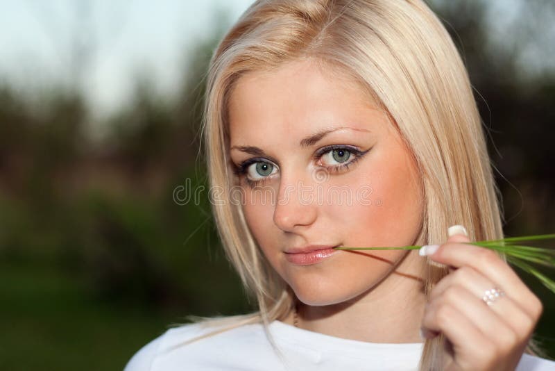 Young blonde with a sprig stock photo. Image of face - 26921360