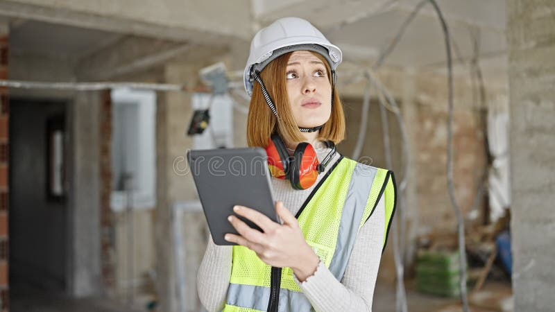 Young Blonde Woman Architect Using Touchpad with Serious Expression at ...
