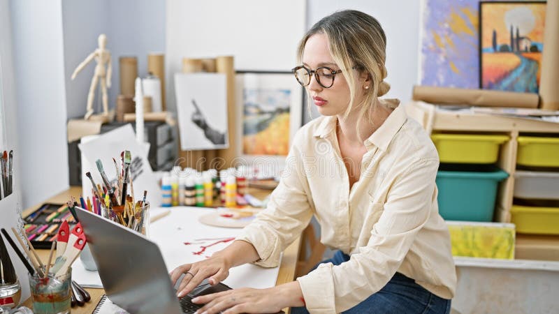 Young Blonde Woman Artist Using Laptop at Art Studio Stock Image ...
