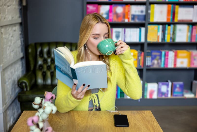 Young Blonde Woman Drinking Coffee with a Book Stock Photo - Image of ...
