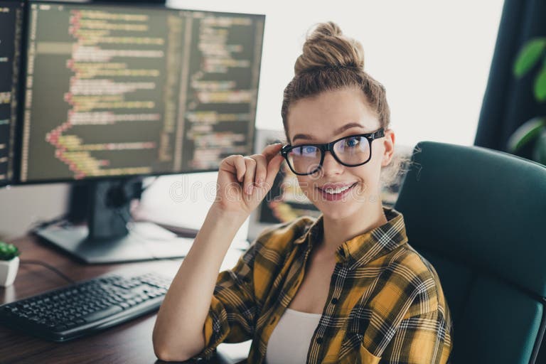 Young Woman Programmer in Casual Attire Working on Her Computer in a ...
