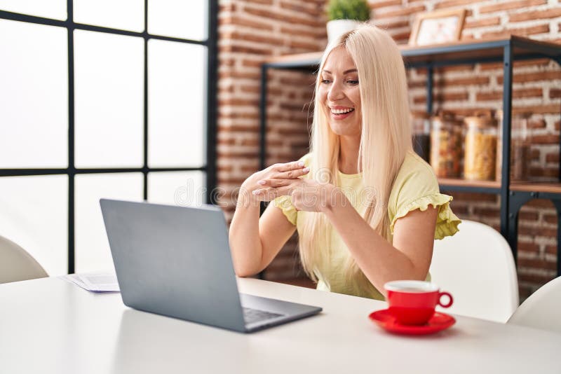 Young Blonde Woman Having Video Call Using Deaf Language at Home Stock ...