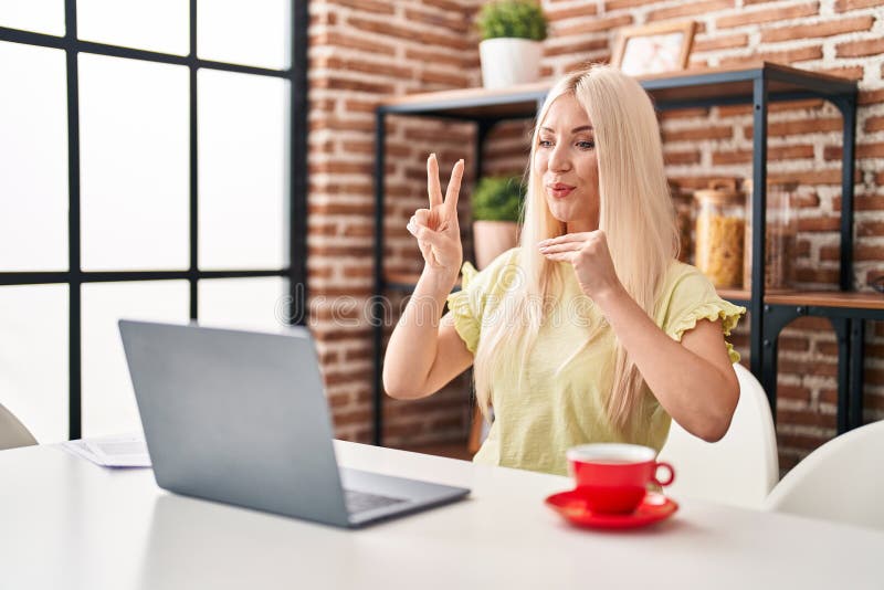 Young Blonde Woman Having Video Call Using Deaf Language at Home Stock ...