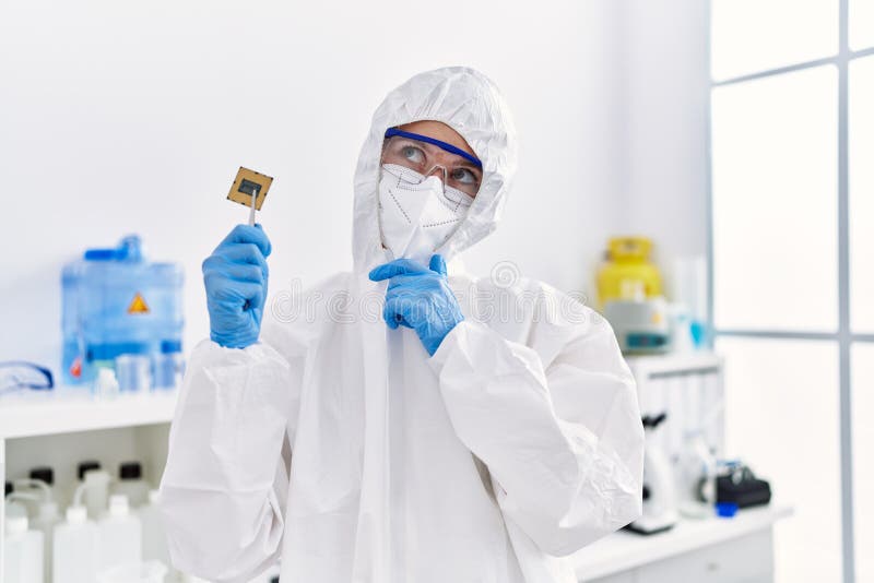 Young Blonde Woman Holding Cpu Computer Processor at Laboratory Serious ...