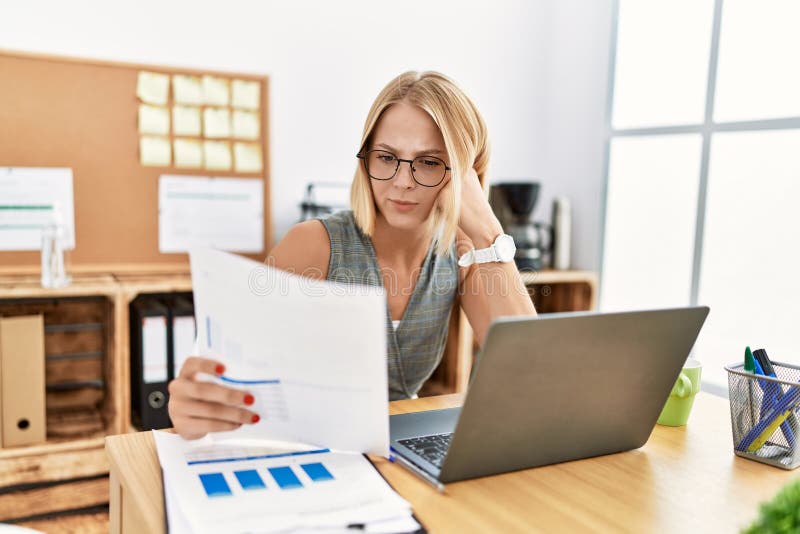 Young Blonde Woman Reading Document Working at Office Stock Image ...