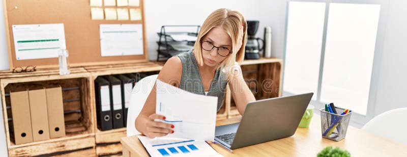 Young Blonde Woman Reading Document Working at Office Stock Photo ...