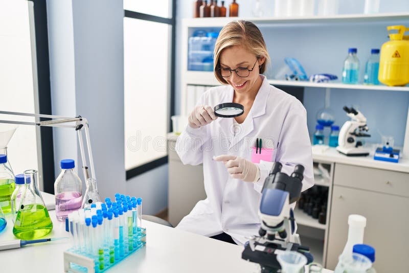 Young Blonde Woman Scientist Looking Sample Using Loupe at Laboratory ...