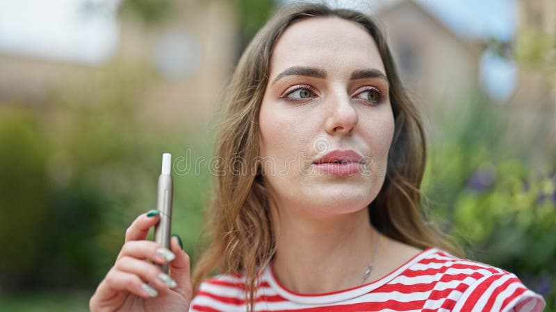 Young Blonde Woman Smoking Vaper at Park Stock Image - Image of ...