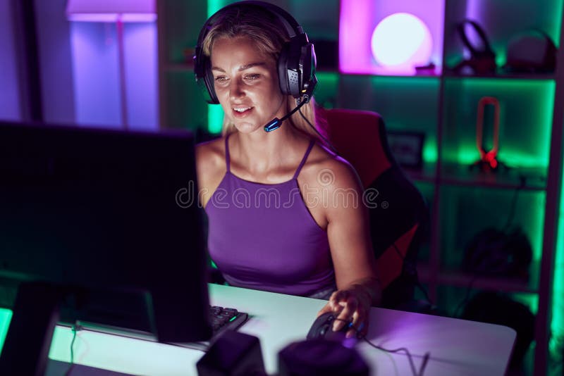 Young Blonde Woman Streamer Playing Video Game Using Computer at Gaming ...