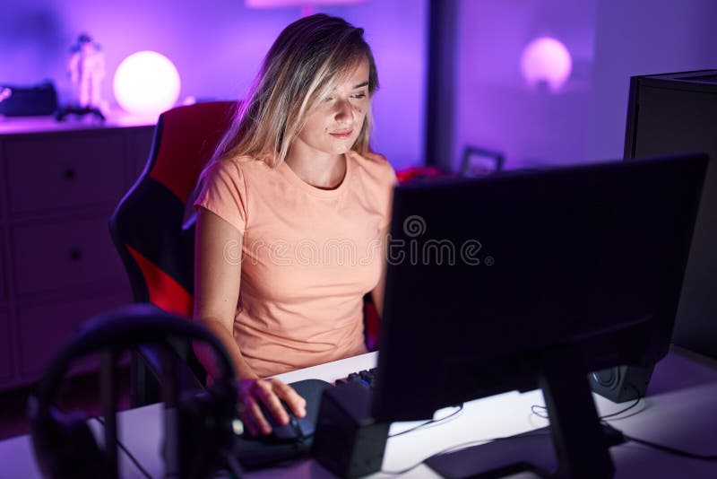Young Blonde Woman Streamer Playing Video Game Using Computer at Gaming ...