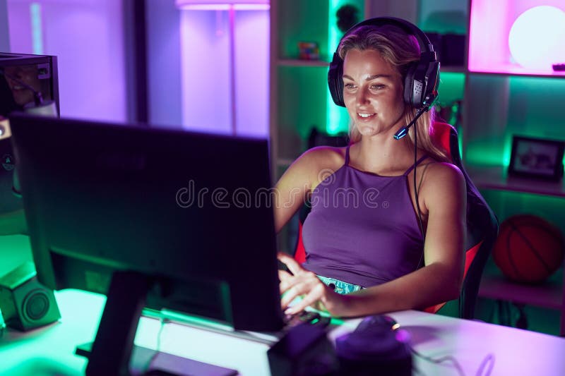 Young Blonde Woman Streamer Playing Video Game Using Computer at Gaming ...