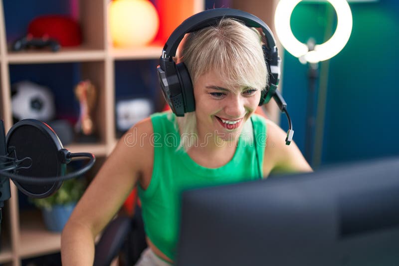 Young Blonde Woman Streamer Playing Video Game Using Computer at Gaming ...
