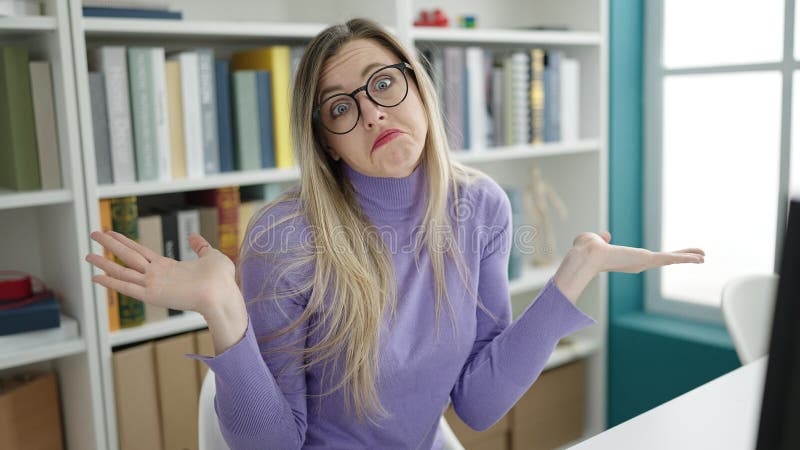 Young Blonde Woman Student Standing with I Dont Know Expression at ...