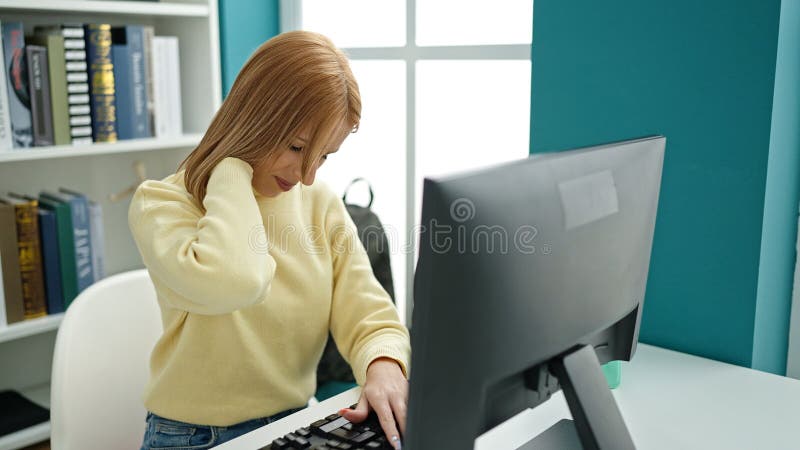 Young Blonde Woman Student Using Computer Stressed at University ...