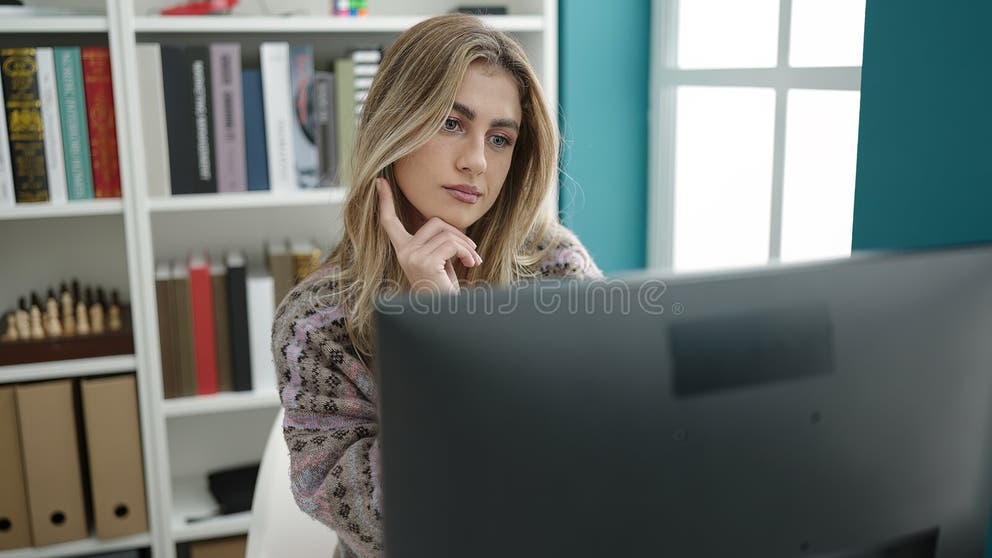 Young Blonde Woman Student Using Computer Studying with Doubt ...