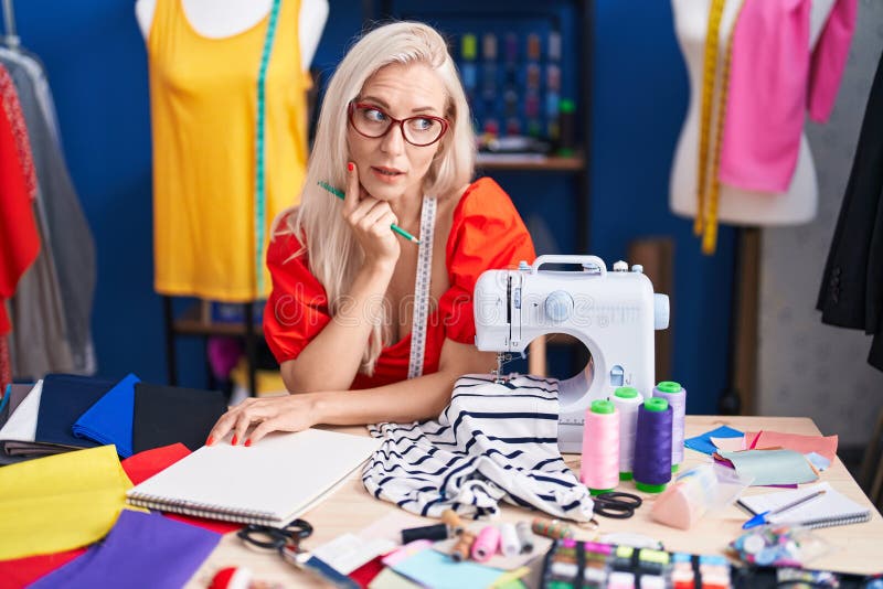 Young Blonde Woman Tailor Stressed Using Sewing Machine at Sewing ...
