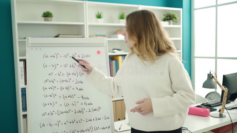 Young Blonde Woman Teacher Explaining Maths Exercise at University ...