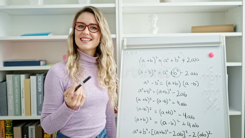 Young Blonde Woman Teacher Teaching Maths Lesson at Classroom Stock ...