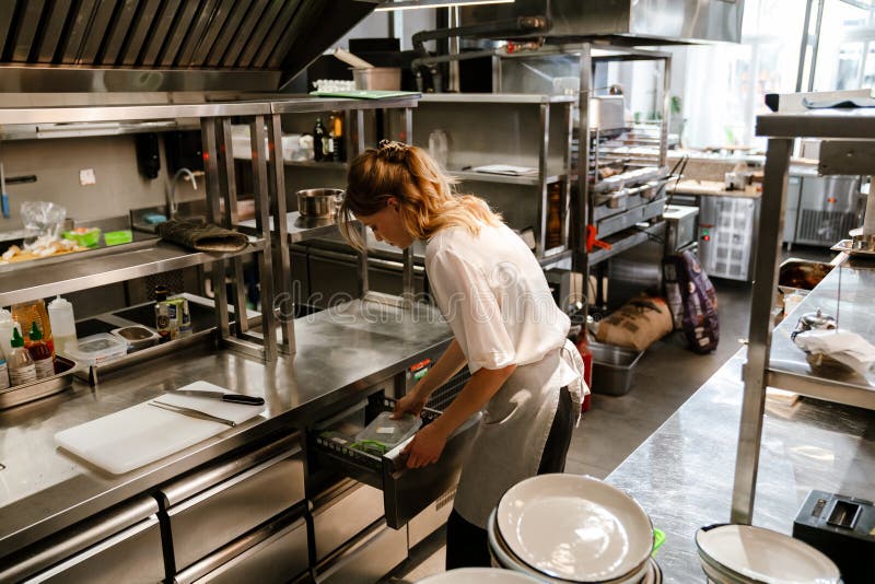 Young Woman Wearing Apron Working in Restaurant Kitchen Stock Photo ...