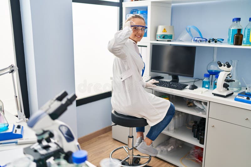 Young Blonde Woman Wearing Scientist Uniform Using Computer Working at ...