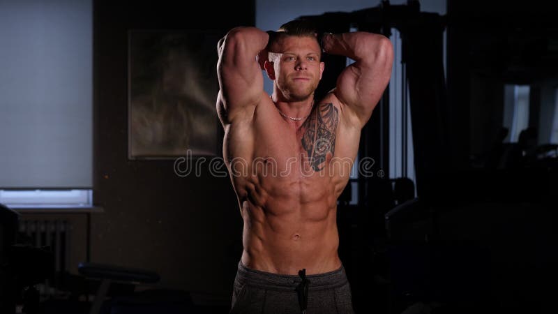 Young Bodybuilder with a Bare Torso Posing in a Gym. 60 To 24fps 4K ...