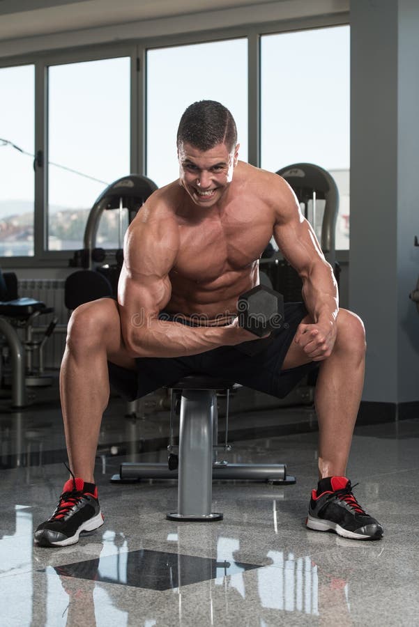 Young Bodybuilder Doing Heavy Weight Exercise for Biceps Stock Photo ...