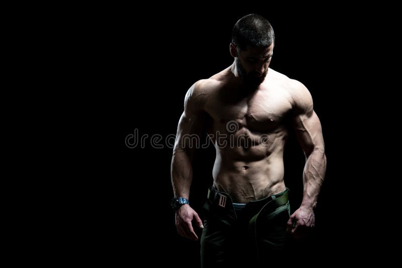 Muscular Man Flexing Muscles on Black Background Stock Photo - Image of ...