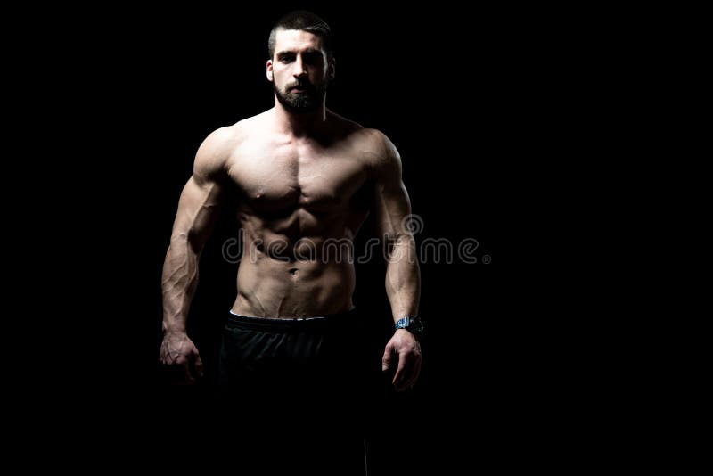 Muscular Man Flexing Muscles on Black Background Stock Image - Image of ...
