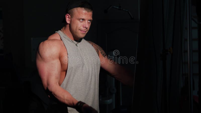 A Young Bodybuilder Plays Sports on a Sunny Day by the River and Does ...