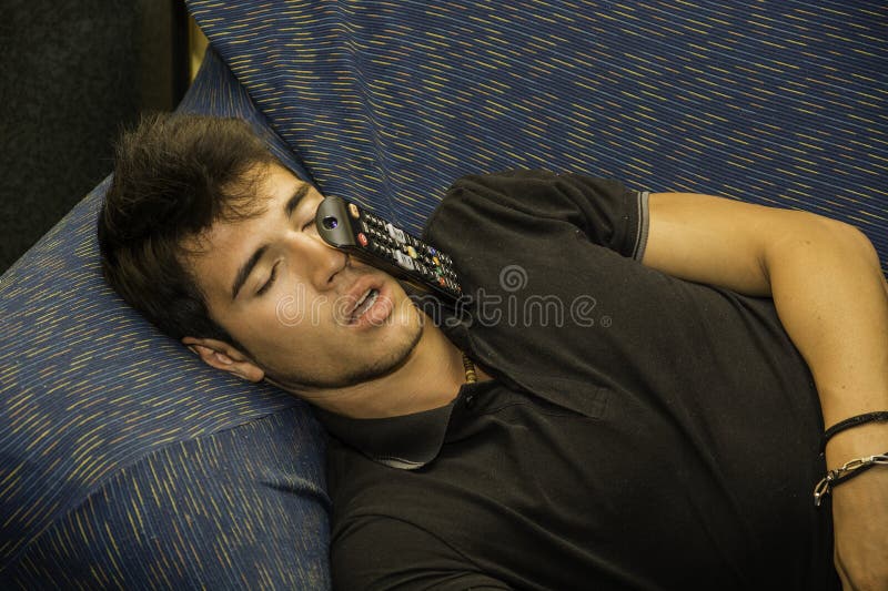 Young Bored Man Sleeping on Sofa Watching Television Stock Photo ...